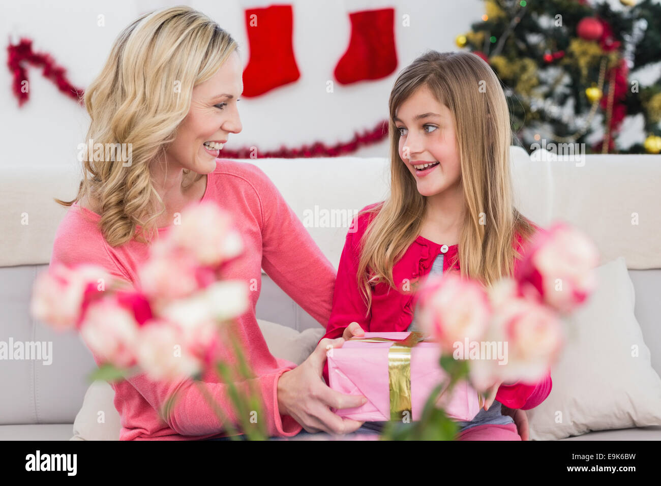 Little girl giving her mother a christmas gift Stock Photo - Alamy