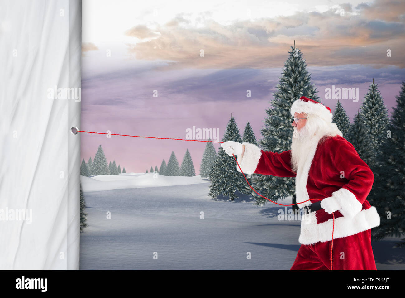 Composite image of santa pulls something with a rope Stock Photo - Alamy