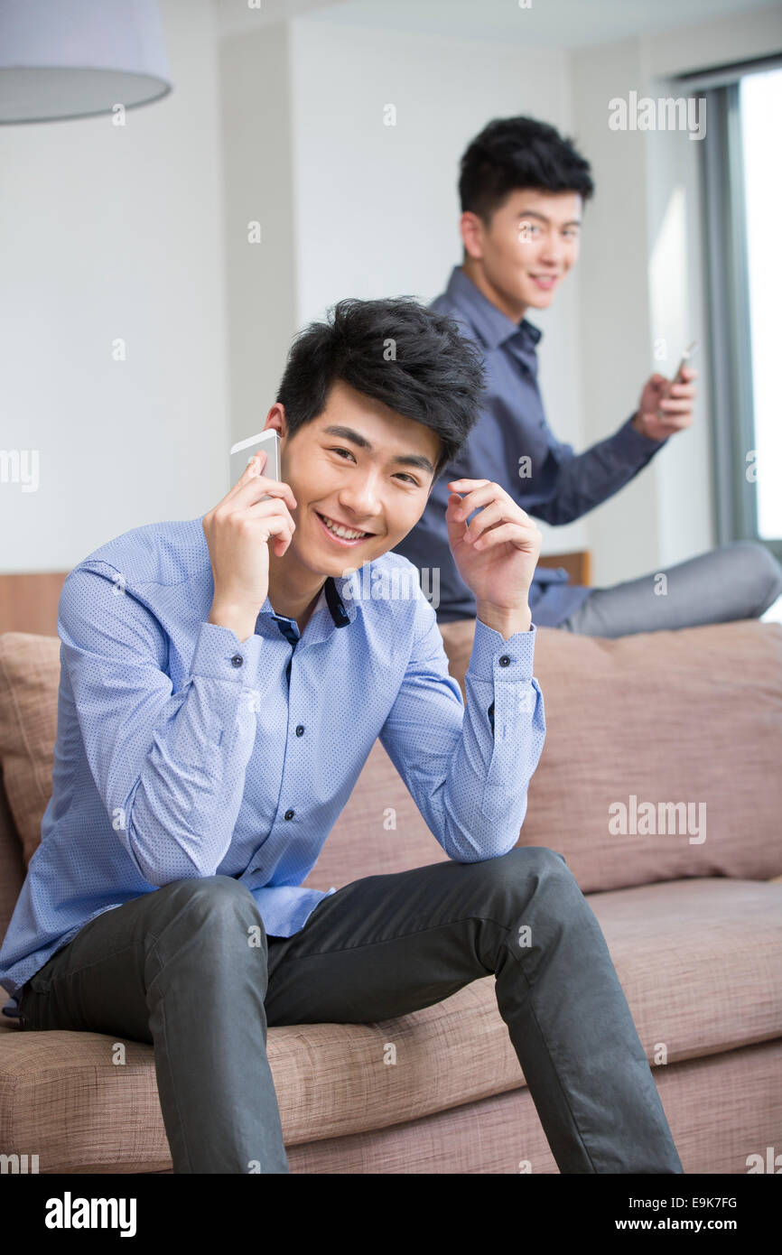 Young men with smart phones Stock Photo - Alamy