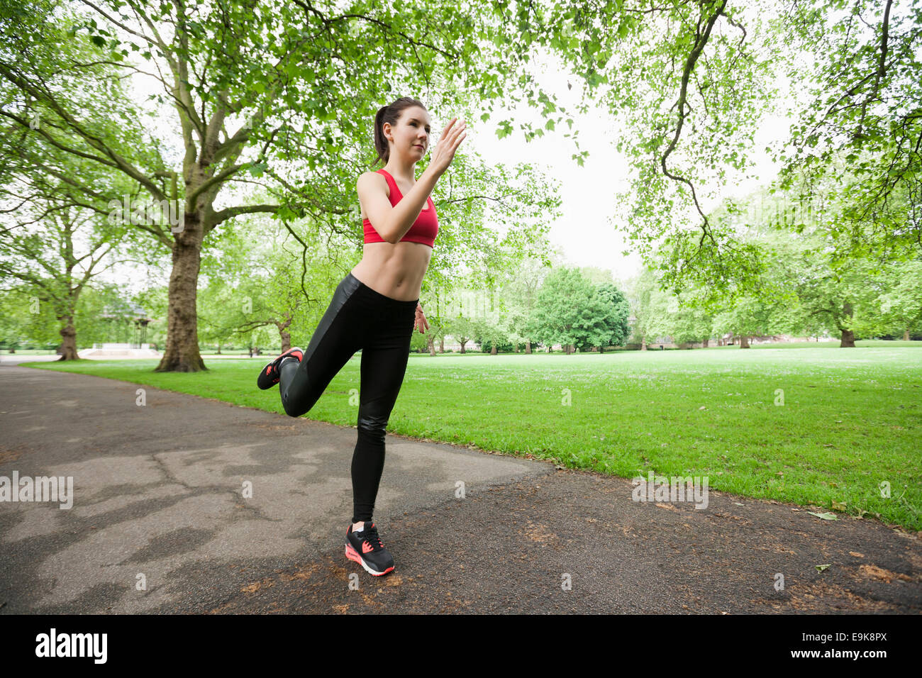 Full length of beautiful fit woman jogging in park Stock Photo - Alamy