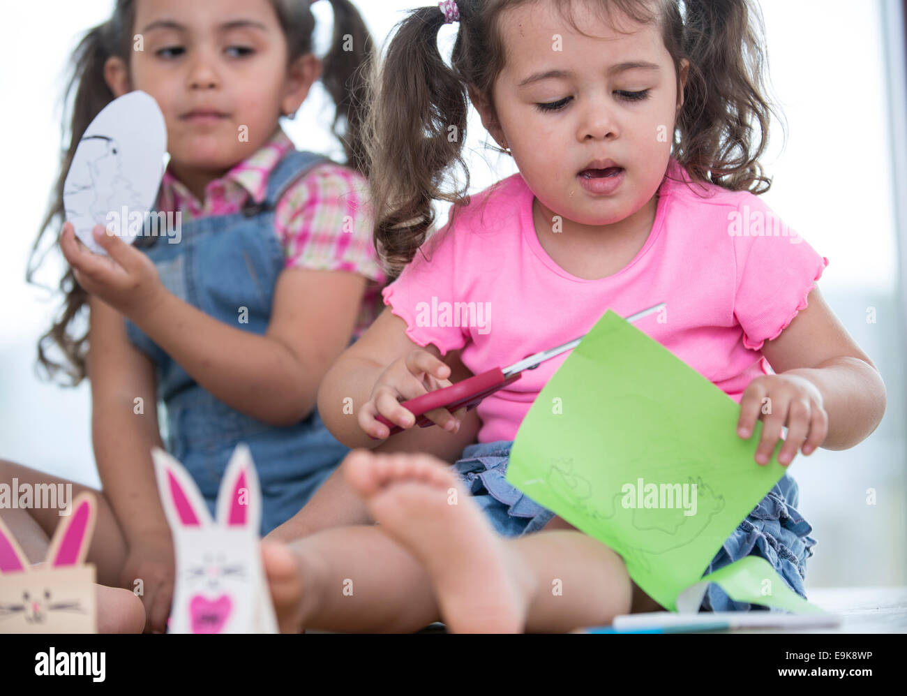 Cute girls with craft papers at home Stock Photo - Alamy