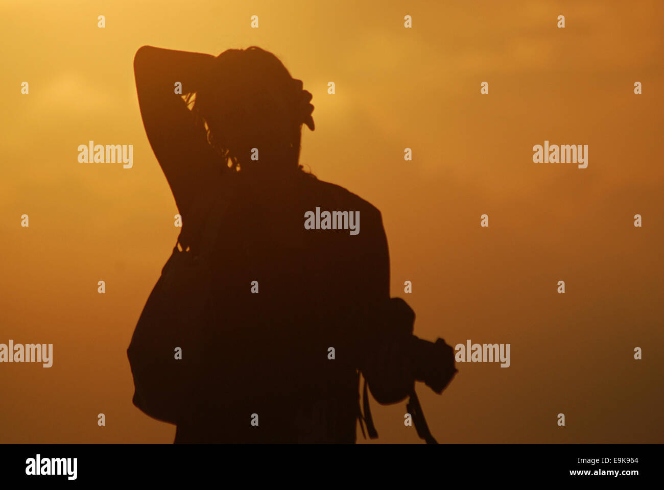 a lady photographer in sunset Stock Photo - Alamy