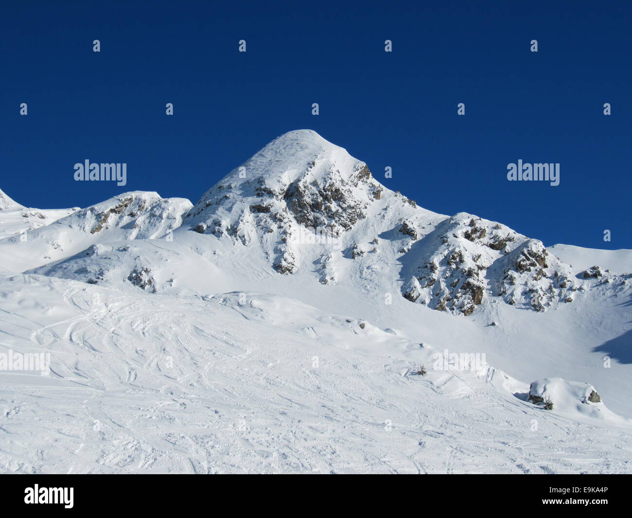 winter alpine mountain scene under a blue sky Stock Photo - Alamy