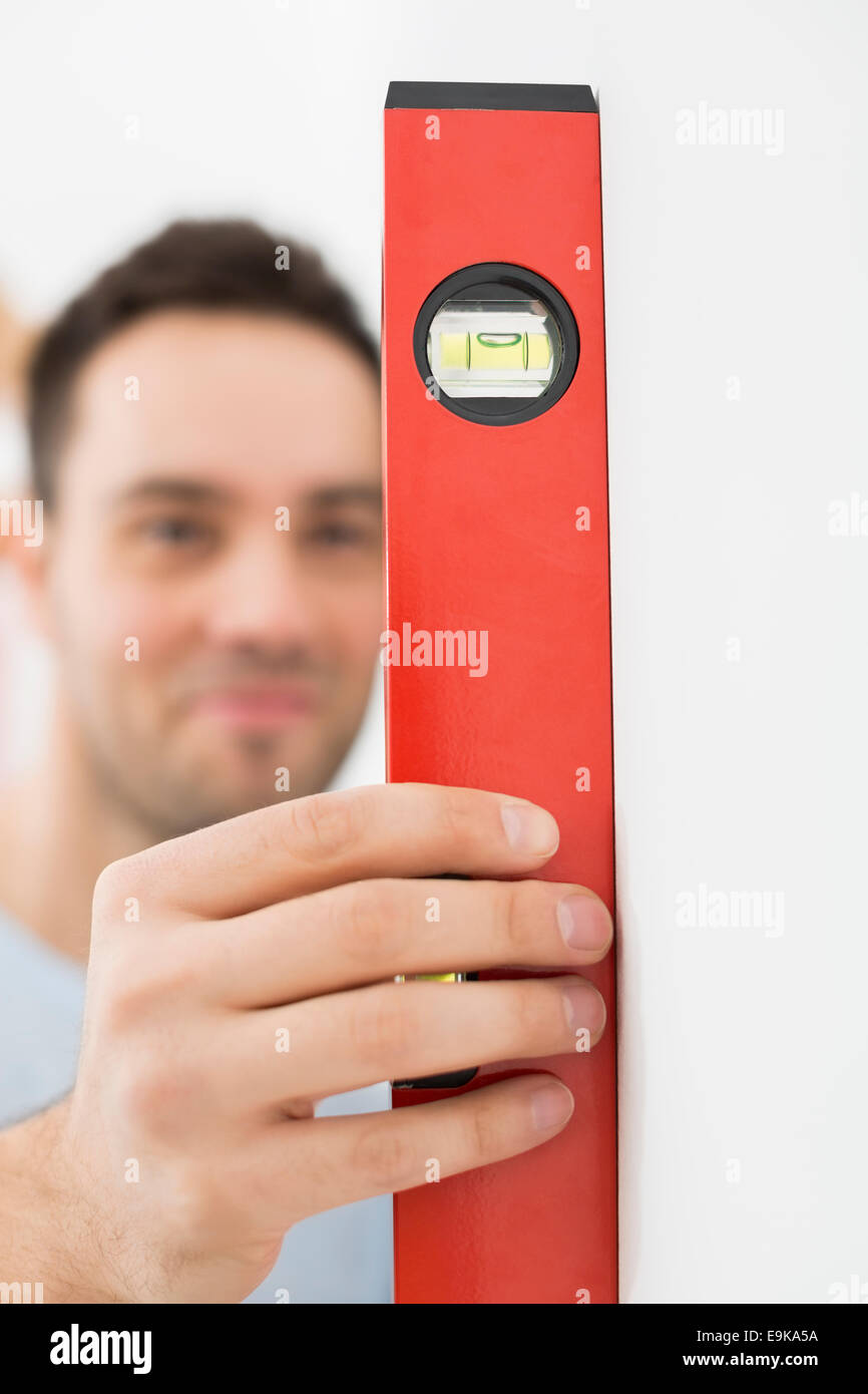 Man using spirit level in new house Stock Photo - Alamy