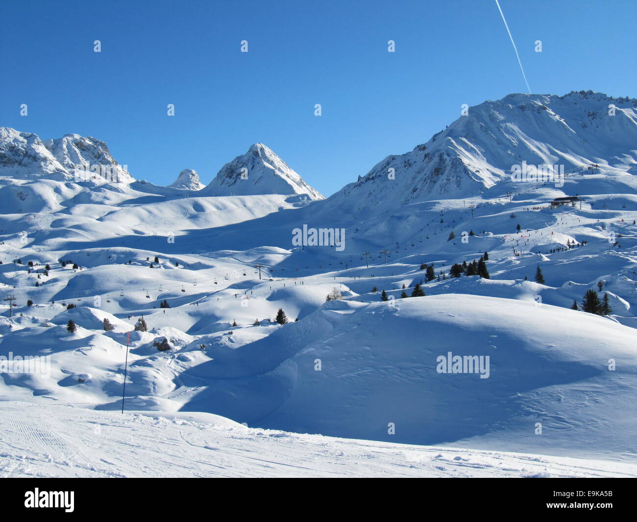 winter alpine mountain scene under a blue sky Stock Photo - Alamy