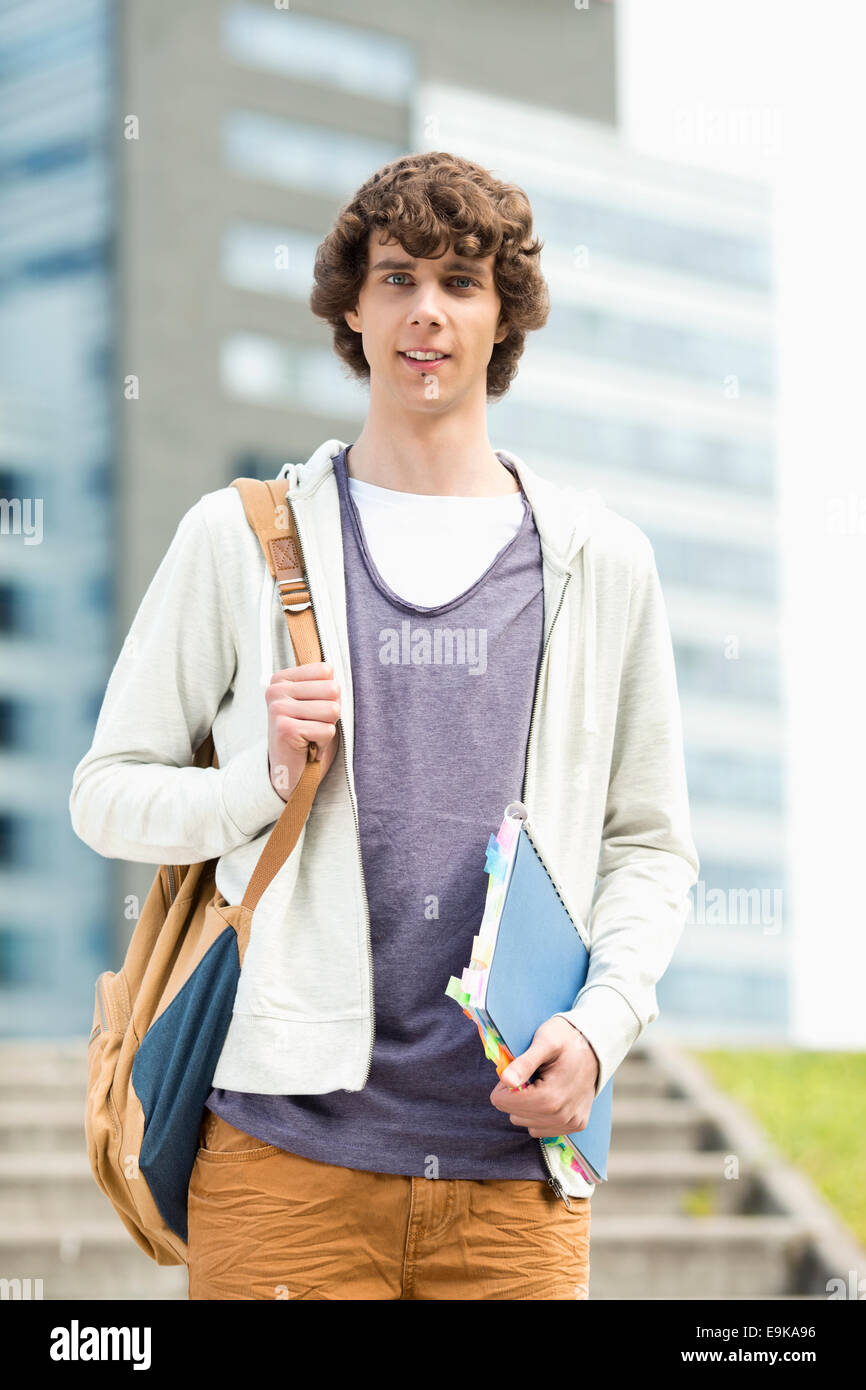 Portrait of young man standing at college campus Stock Photo - Alamy