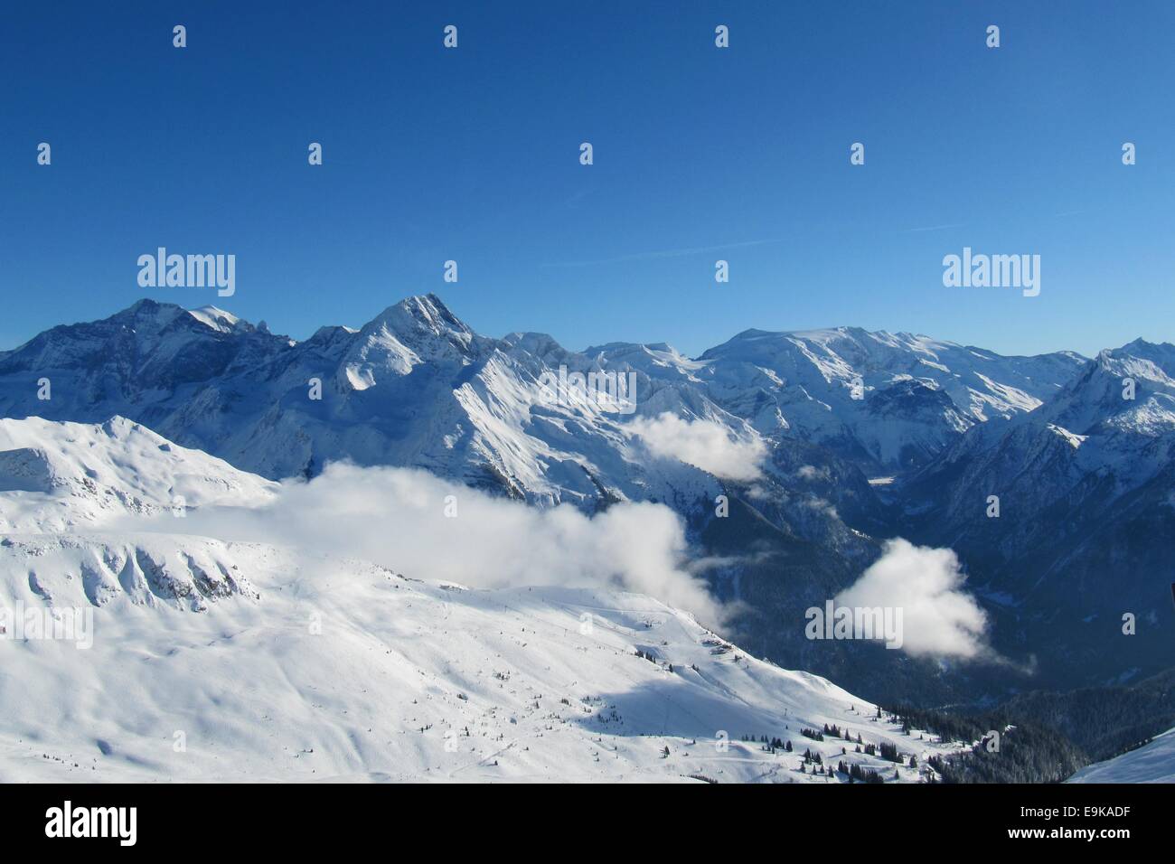 winter alpine mountain scene under a blue sky Stock Photo - Alamy