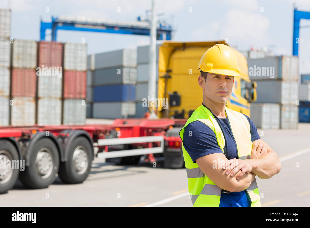 Portrait of confident mid adult man in shipping yard Stock Photo - Alamy
