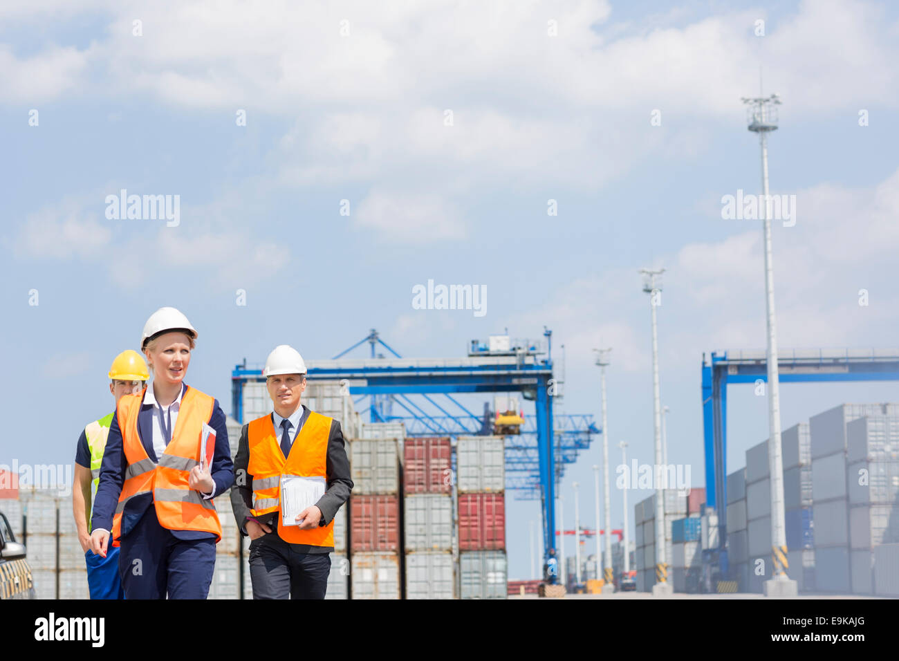 Workers walking in shipping yard Stock Photo - Alamy