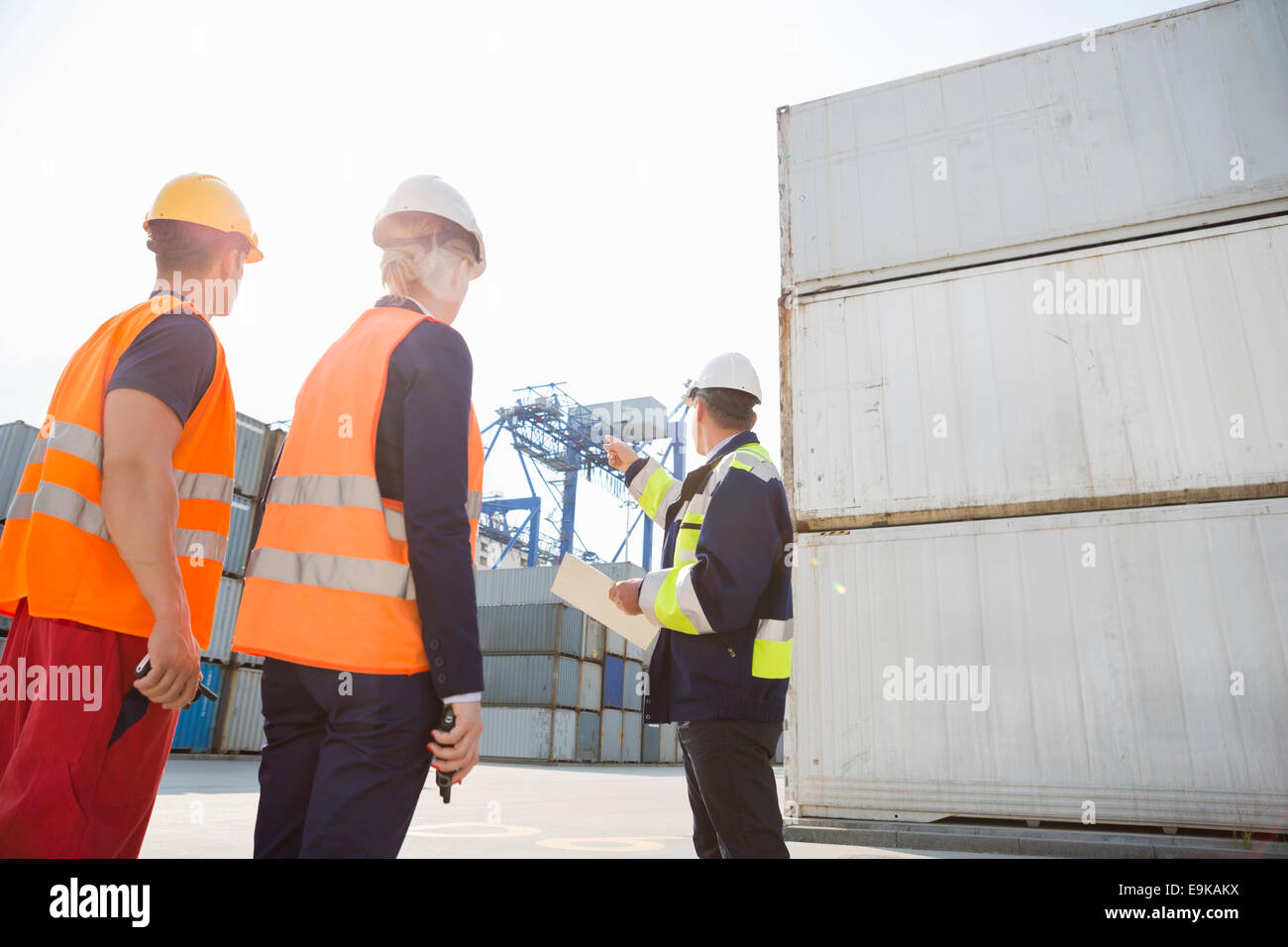 Workers discussing in shipping yard 30s adult hi-res stock photography ...