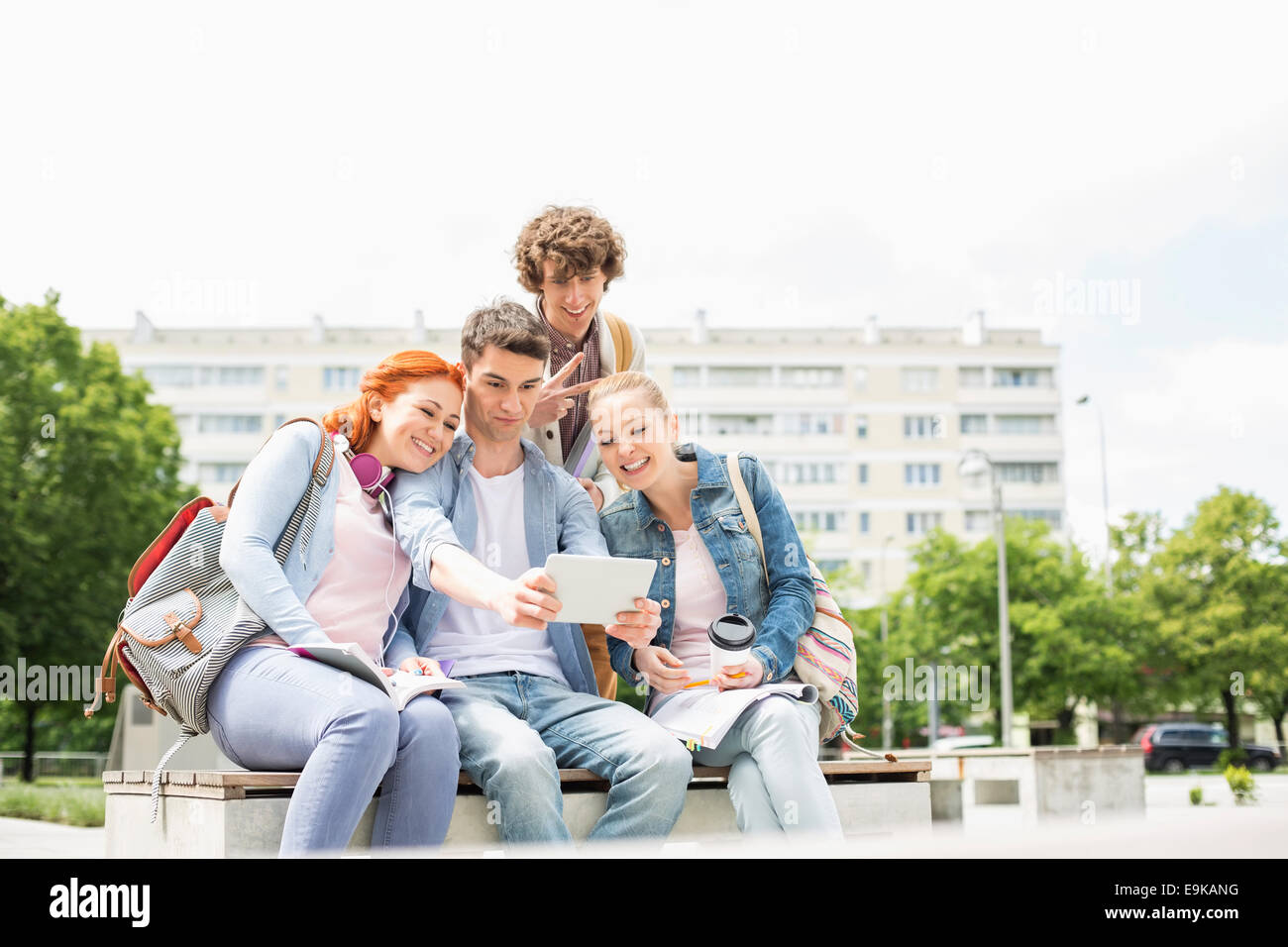Young students photographing themselves through digital tablet at ...