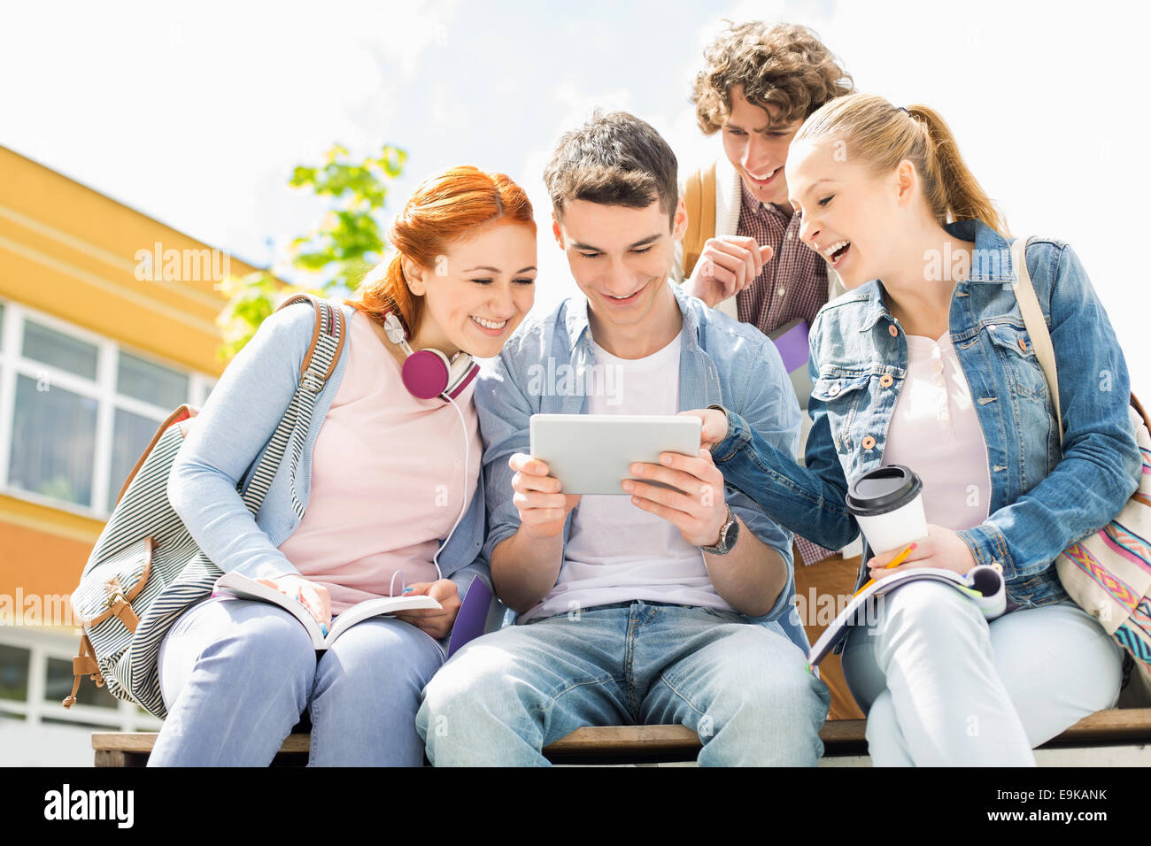 Young students using digital tablet at college campus Stock Photo - Alamy