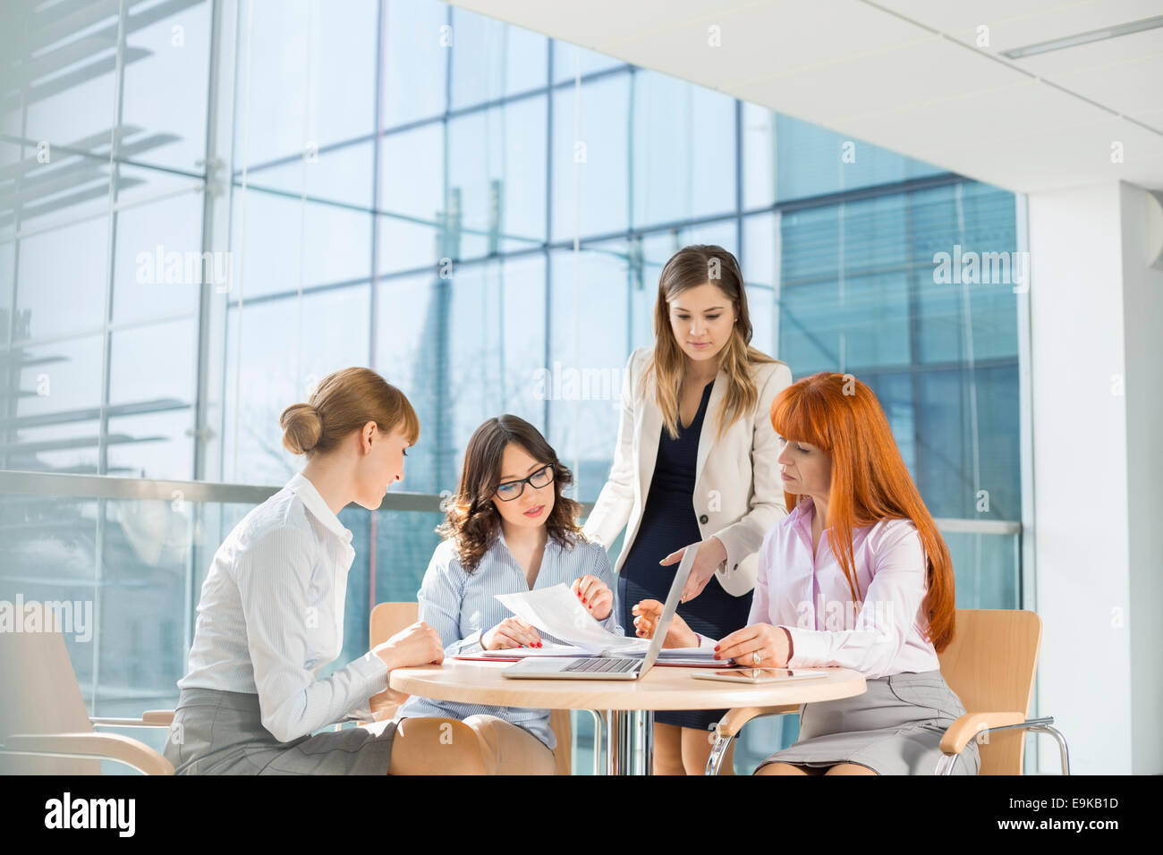 Businesswomen working at table in office Stock Photo - Alamy