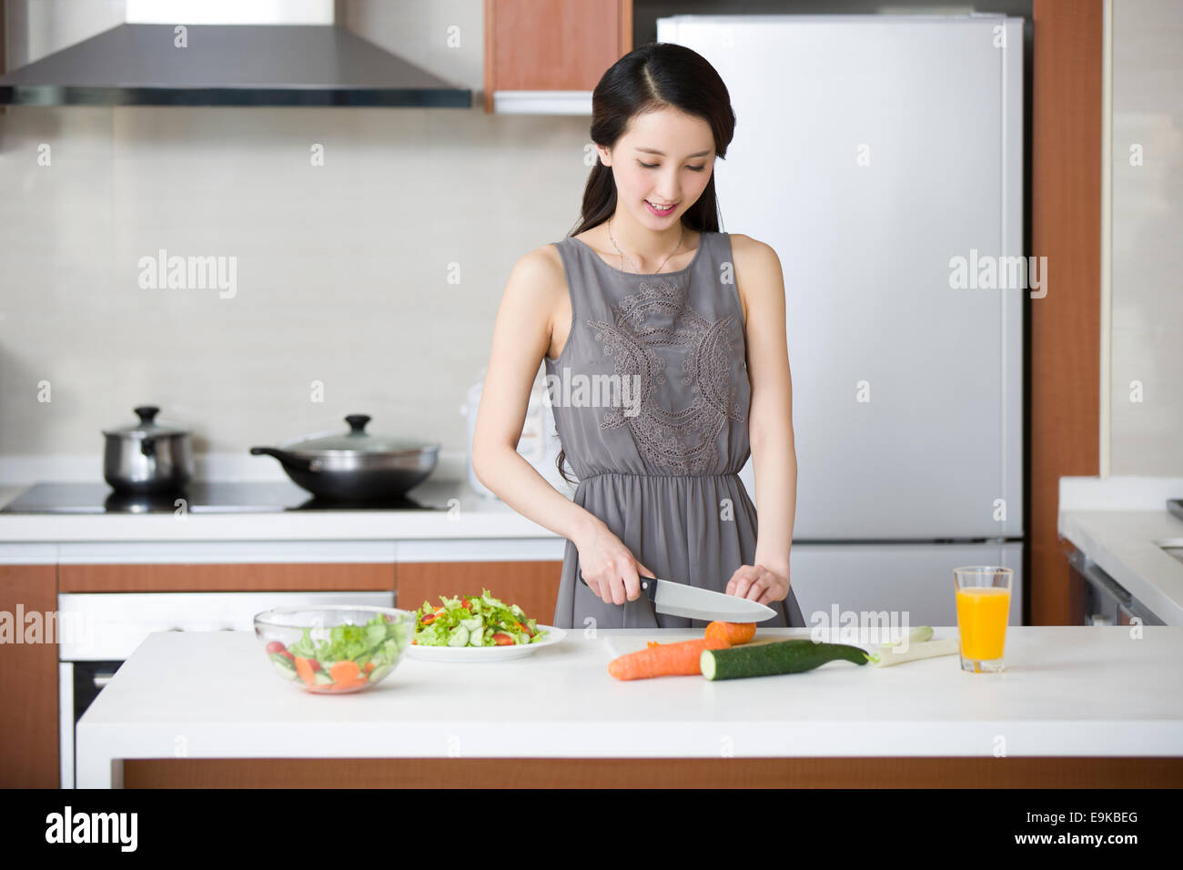 Young woman cooking in the kitchen Stock Photo - Alamy
