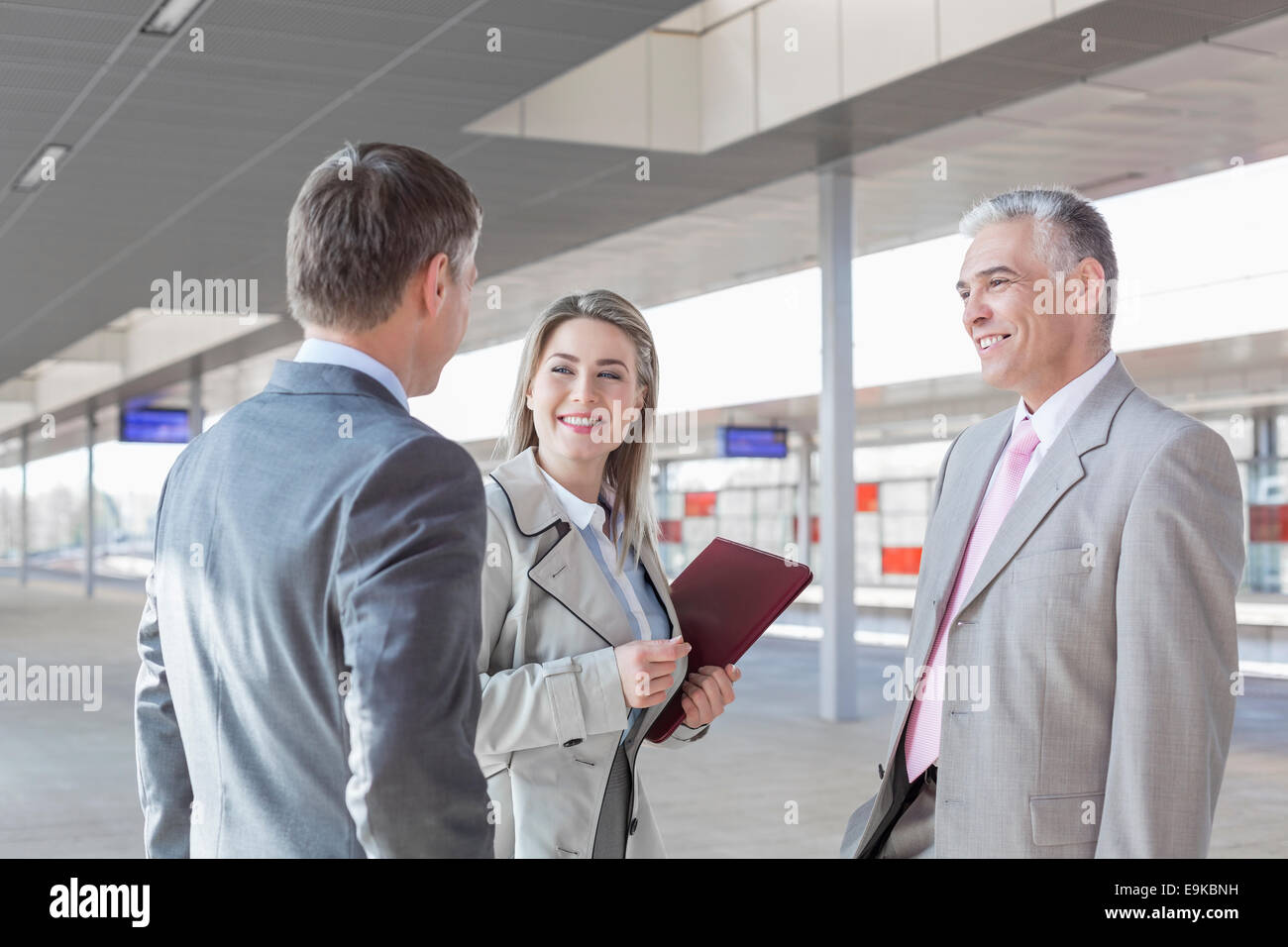 Business people conversing on train platform Stock Photo - Alamy
