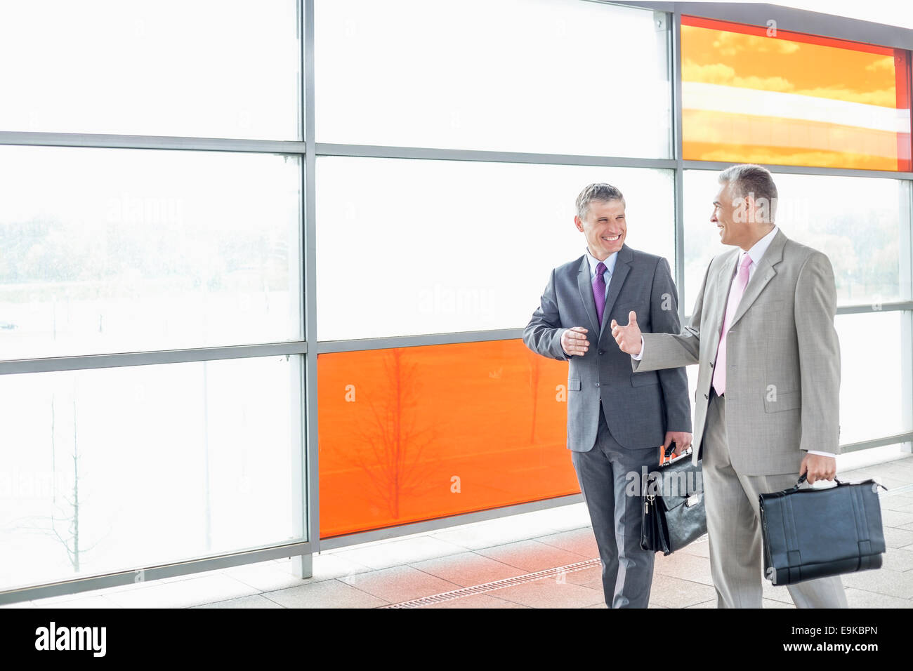 Happy men walking talking hi-res stock photography and images - Alamy