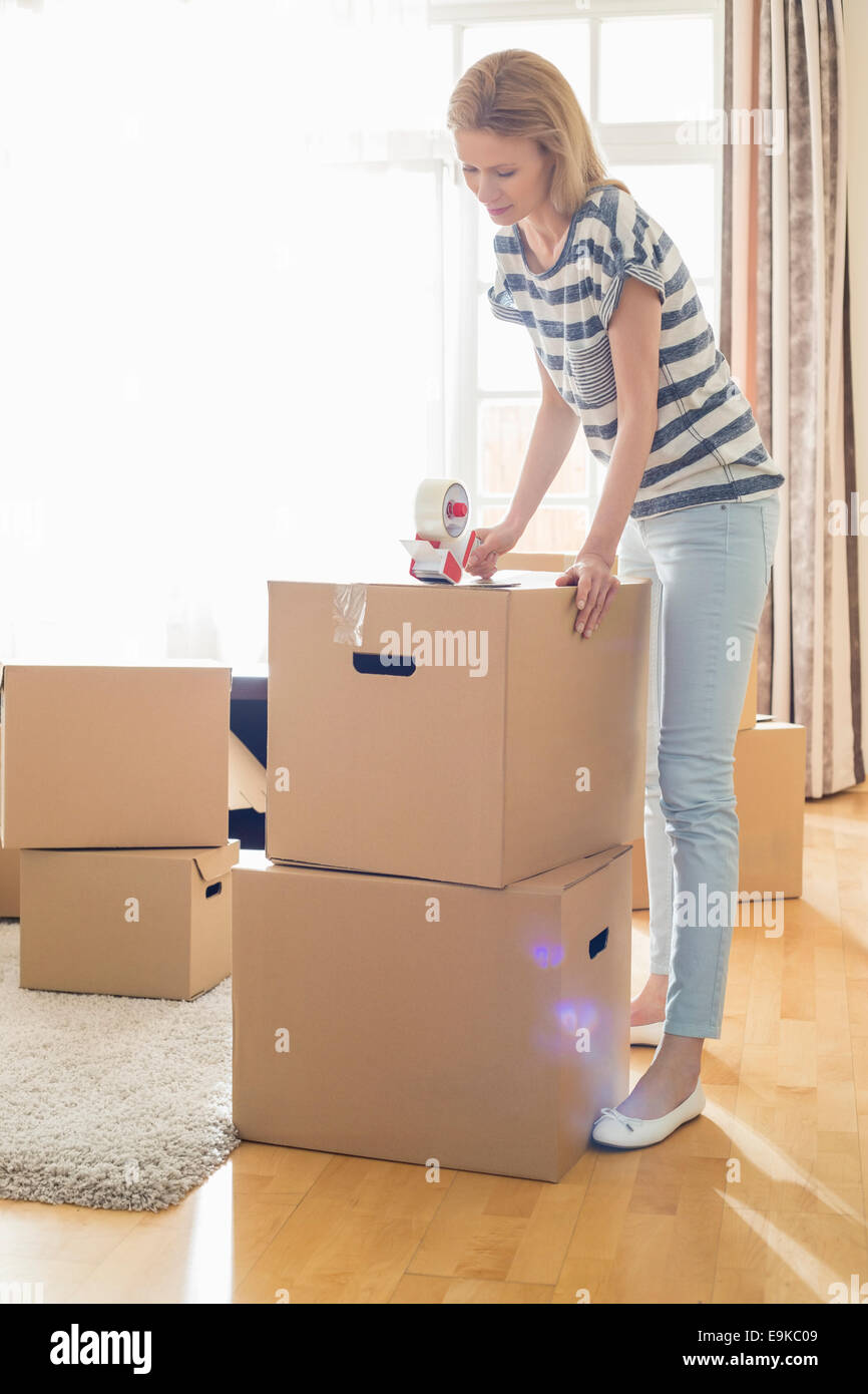 Woman packing cardboard box at home Stock Photo - Alamy