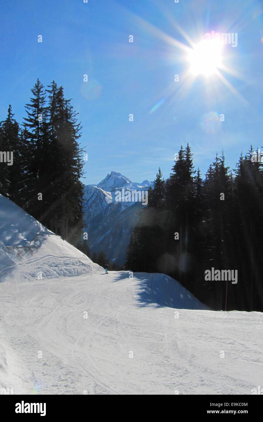 winter alpine mountain scene under a blue sky Stock Photo - Alamy