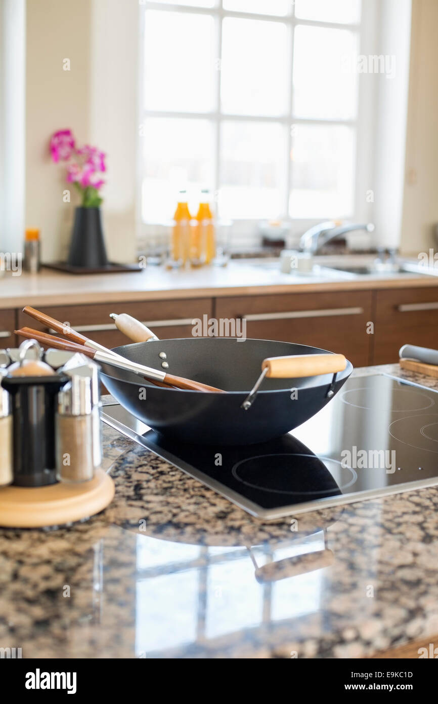 Cooking utensils on stove in kitchen Stock Photo - Alamy