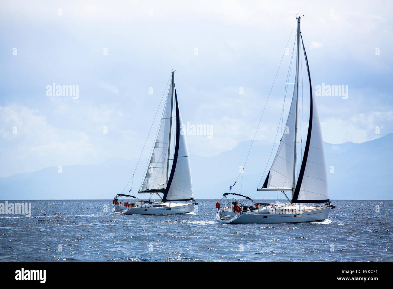 Sailboats in front of the regatta in the morning mist. Luxury yachts in ...