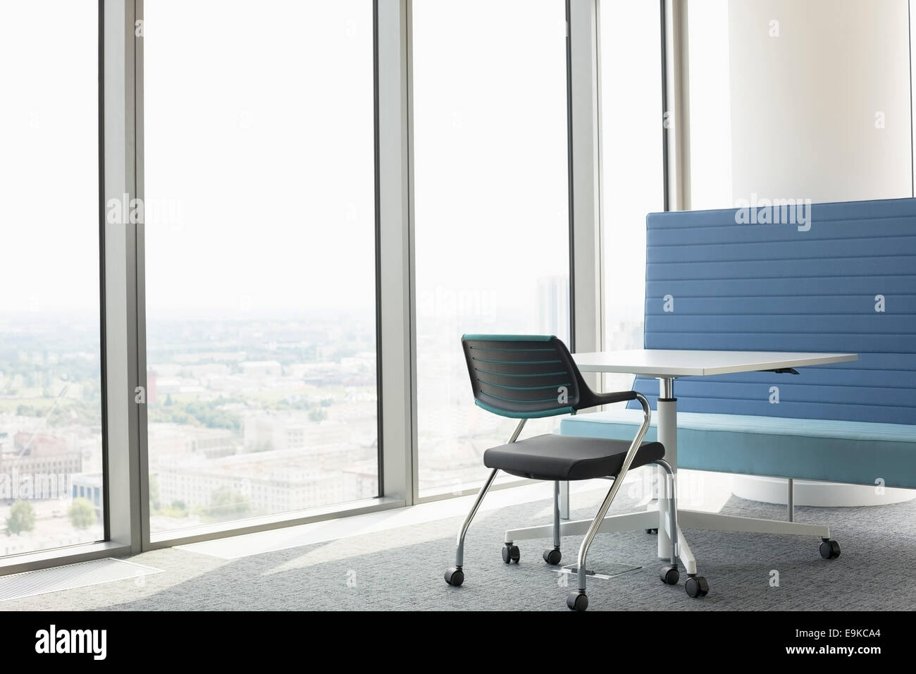 Office furniture near window Stock Photo - Alamy