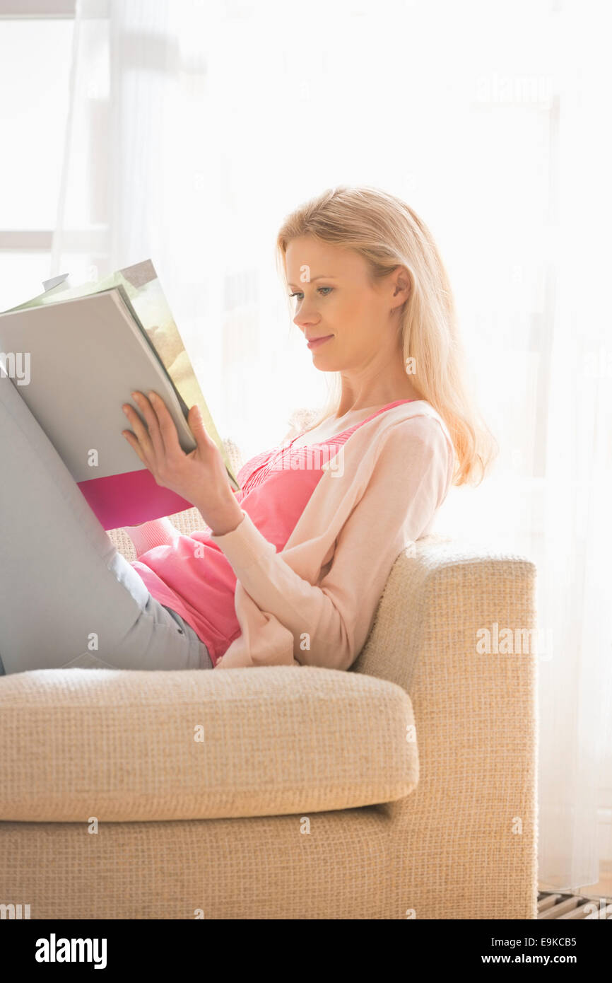 Beautiful woman reading magazine at home Stock Photo - Alamy