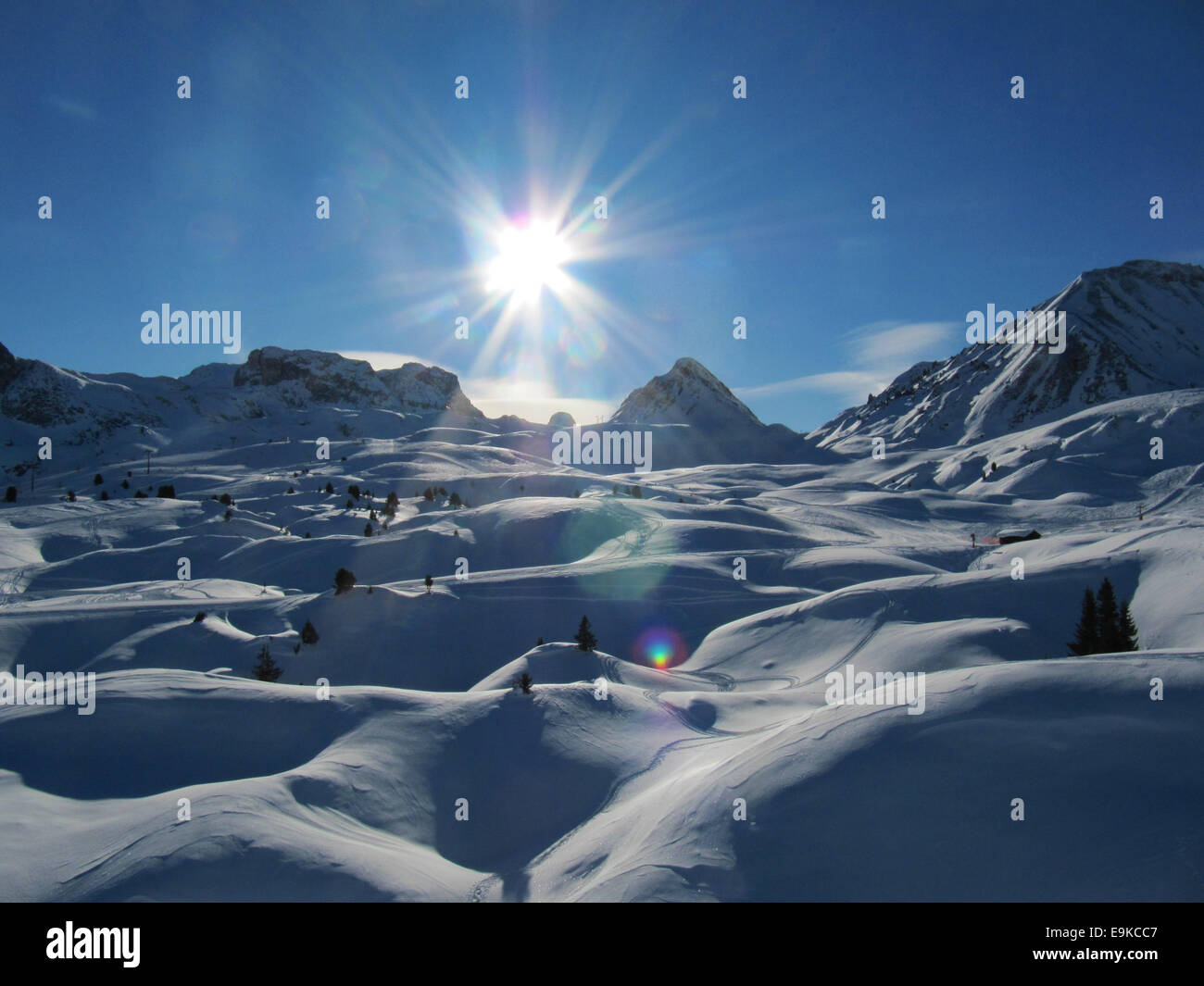 winter alpine mountain scene under a blue sky Stock Photo - Alamy
