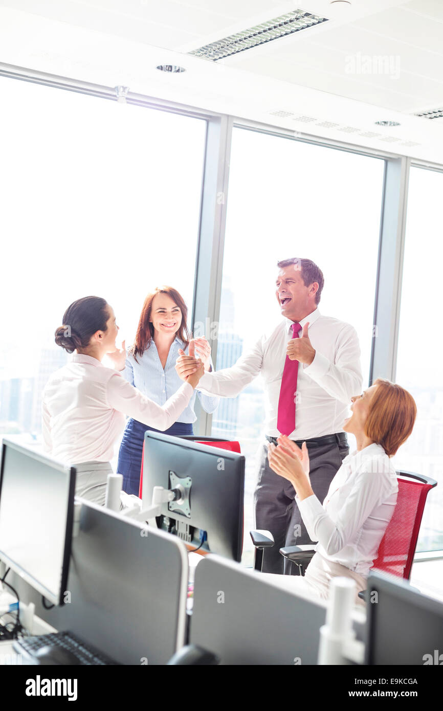 Businesspeople celebrating success in office Stock Photo - Alamy