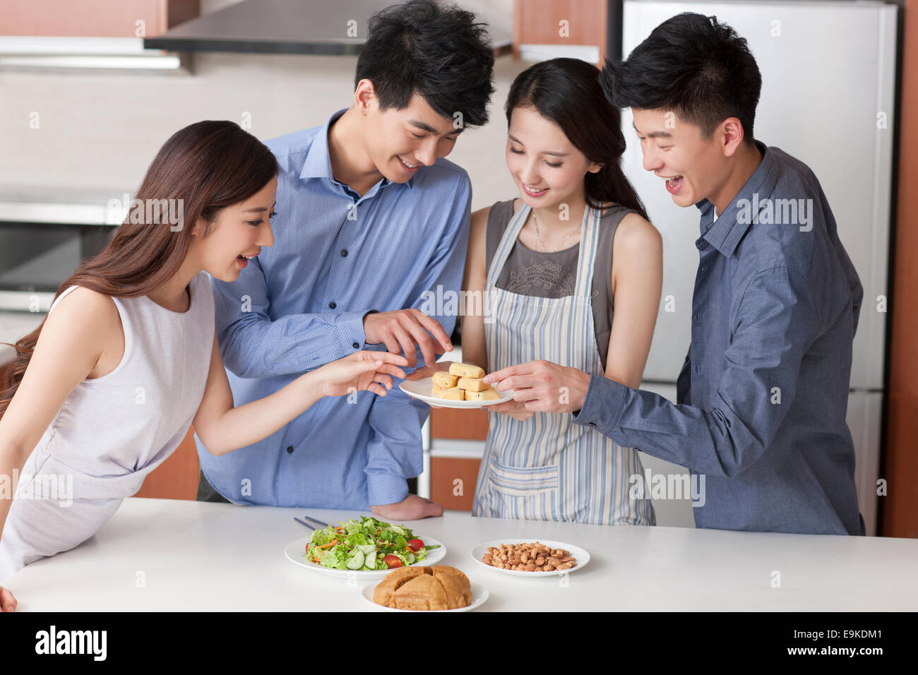 Young woman cooking for her friends in the kitchen Stock Photo - Alamy
