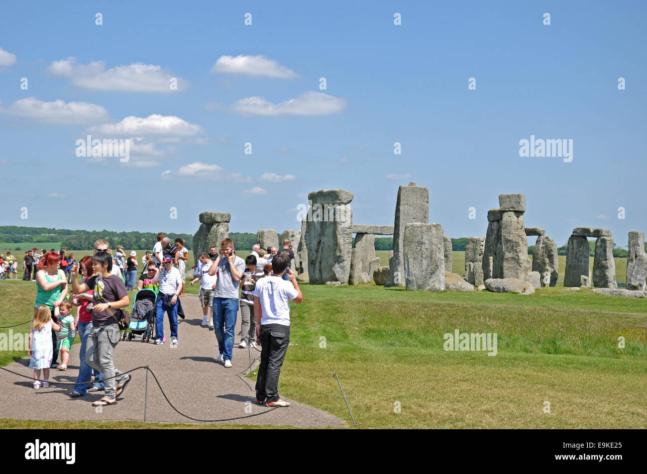 A crowd of tourists on a warm, sunny day at Stonehenge, Wiltshire ...