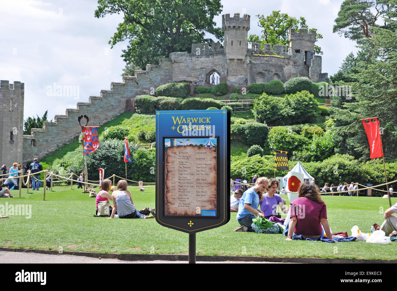 Warwick castle, England, UK. People sitting outside in the sunshine ...