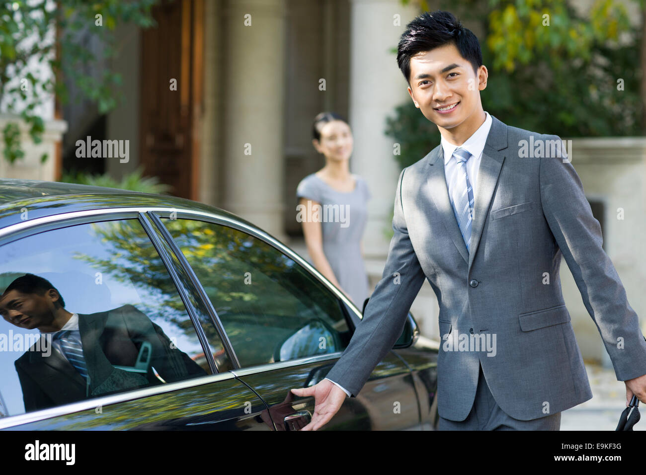 Young businessman opening car door Stock Photo - Alamy
