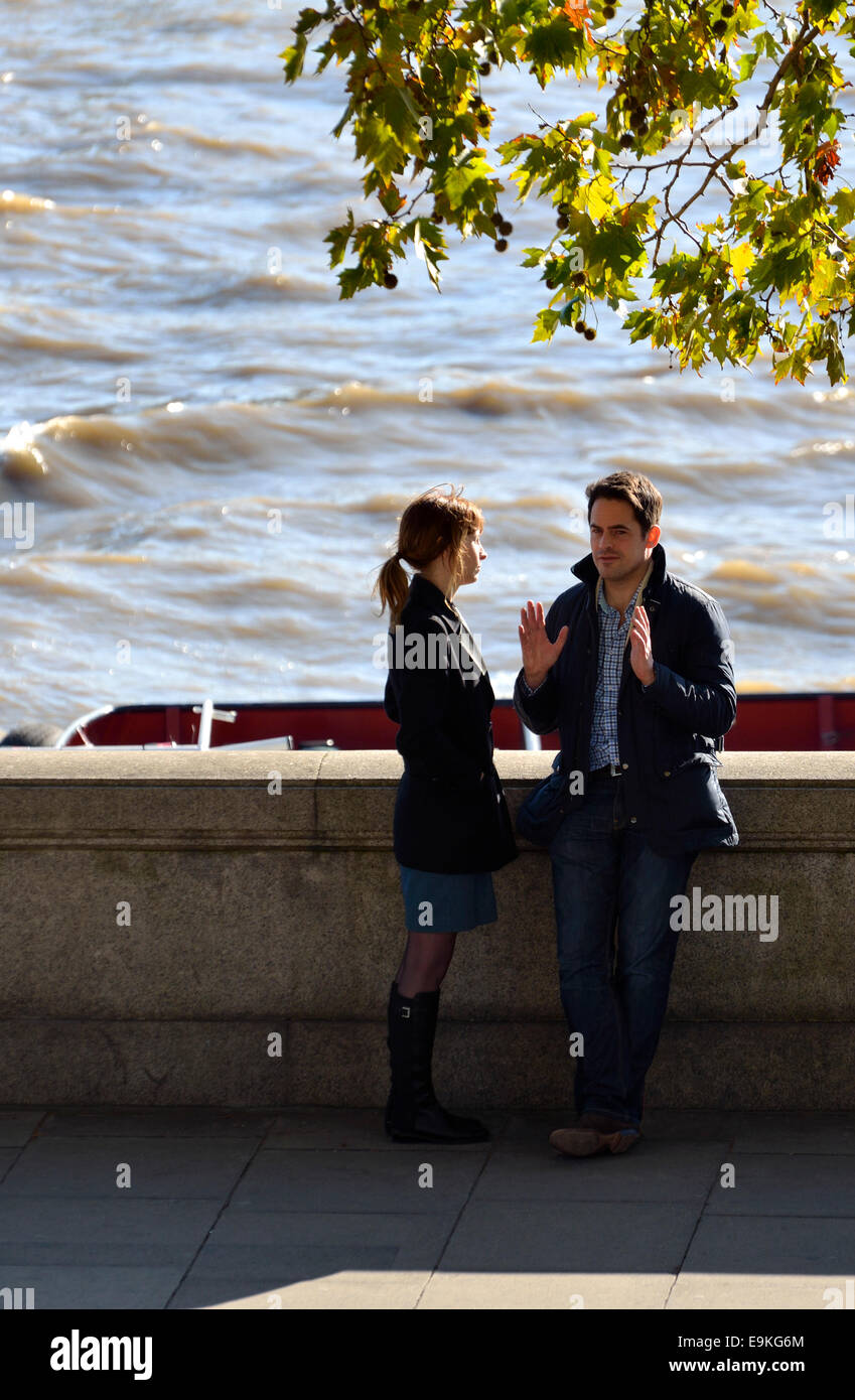 London, England, UK. Young couple talking by the River Thames Stock ...