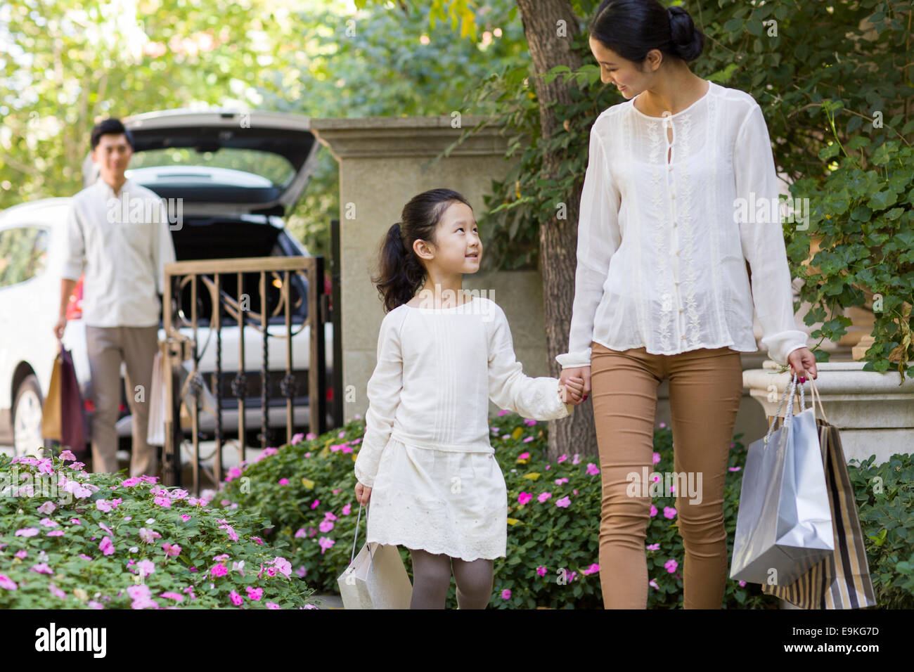 Young family coming back from shopping Stock Photo - Alamy