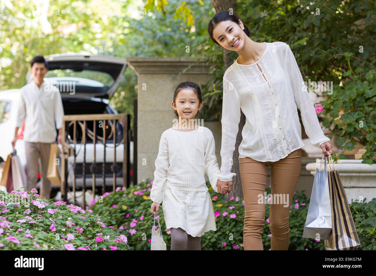 Young family coming back from shopping Stock Photo - Alamy