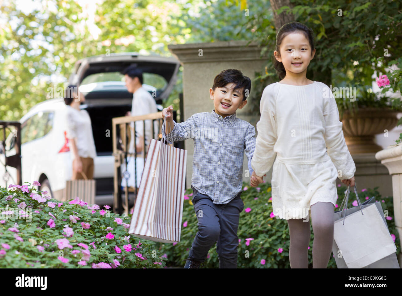 Young family coming back from shopping Stock Photo - Alamy