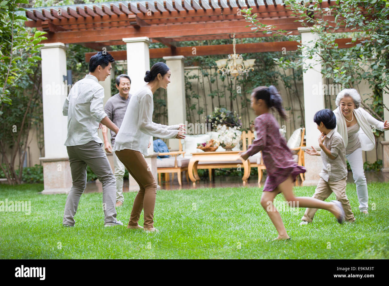 Happy family playing together Stock Photo - Alamy