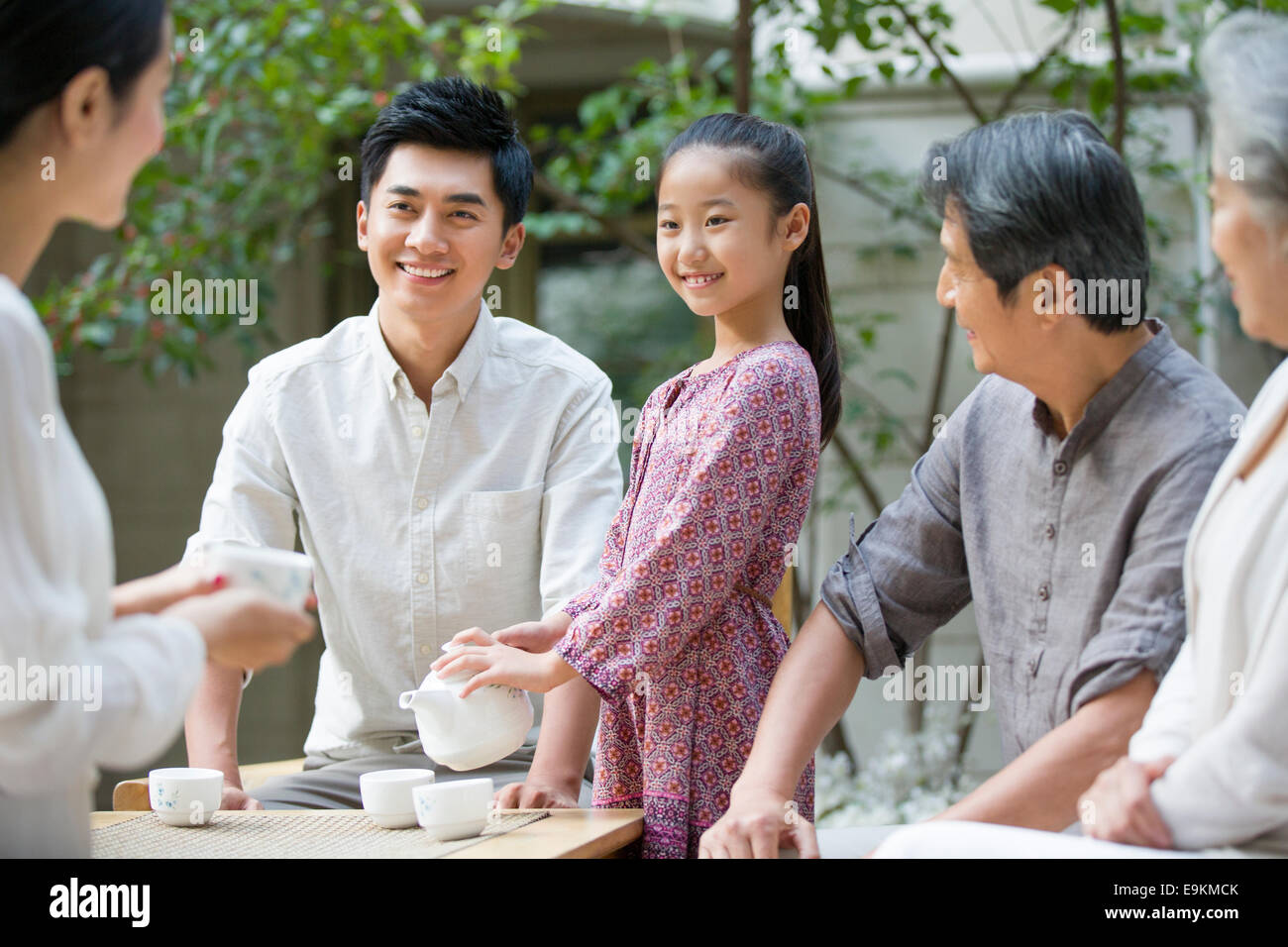 Happy family drinking tea together Stock Photo - Alamy