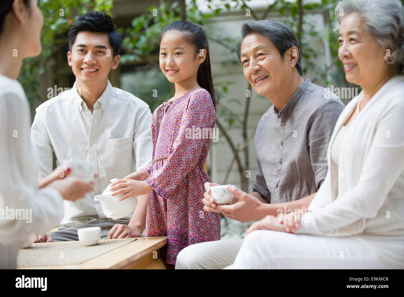 Happy family drinking tea together Stock Photo - Alamy