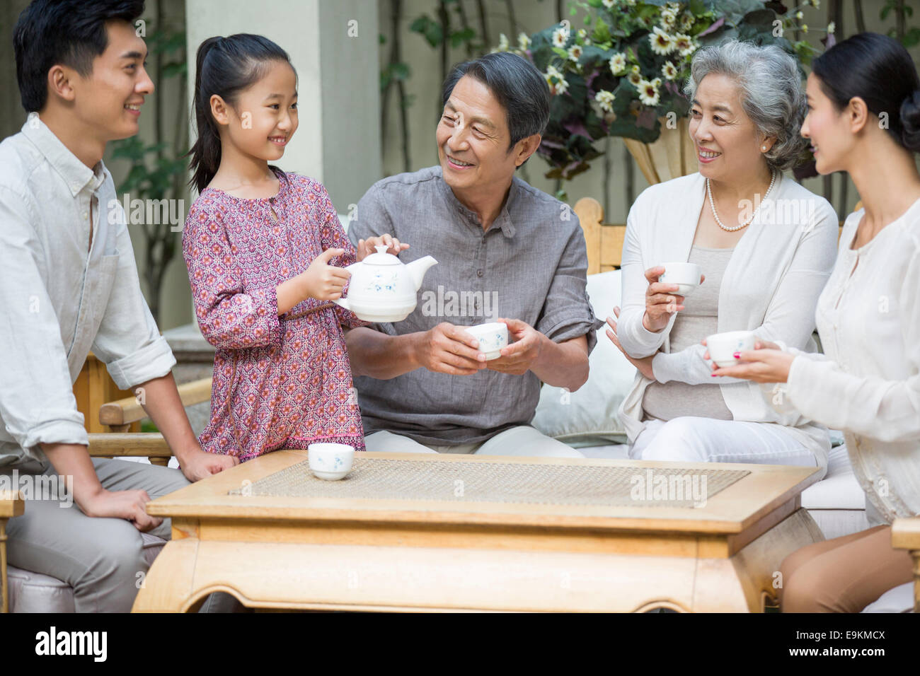 Happy family drinking tea together Stock Photo - Alamy