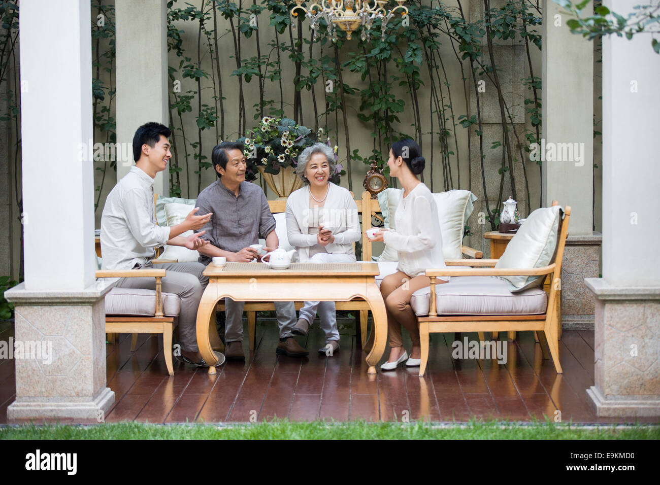 Happy family drinking tea together Stock Photo - Alamy
