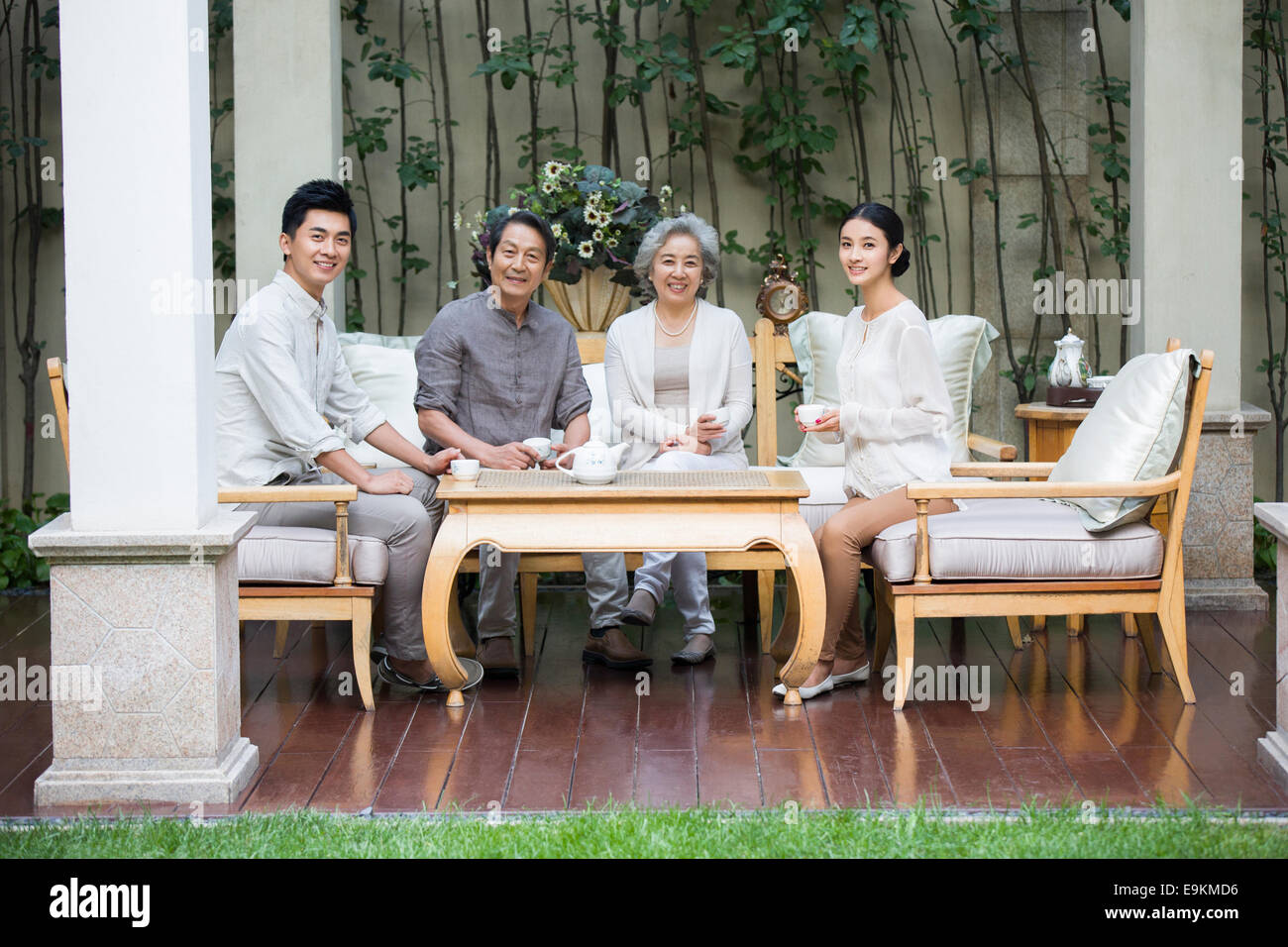 Happy family drinking tea together Stock Photo - Alamy