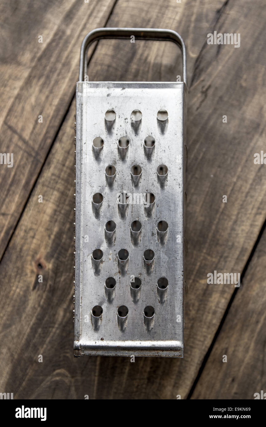 natural aged old rusted grater on the wooden table Stock Photo - Alamy