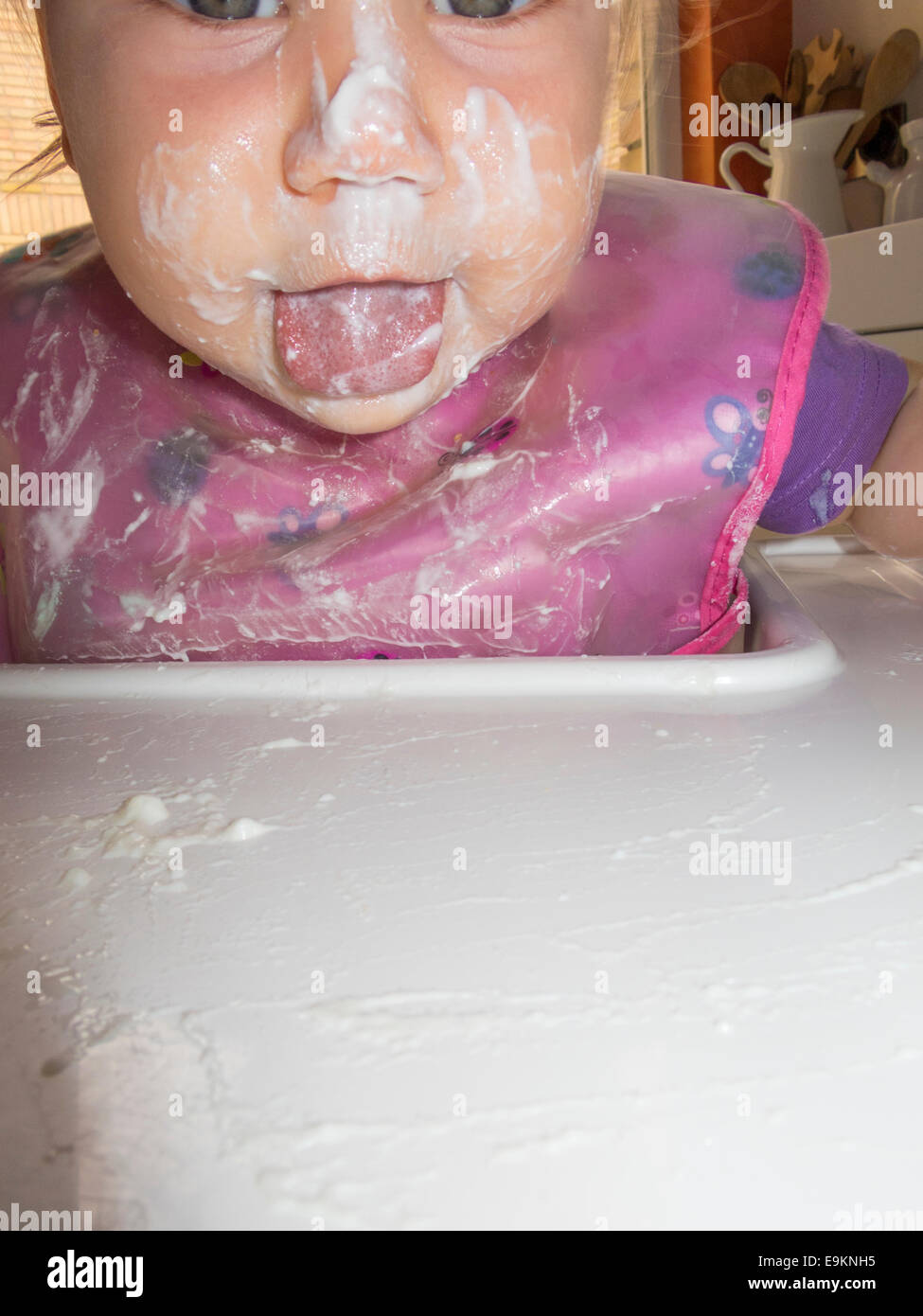 Portrait baby girl eating yogurt hi-res stock photography and images ...
