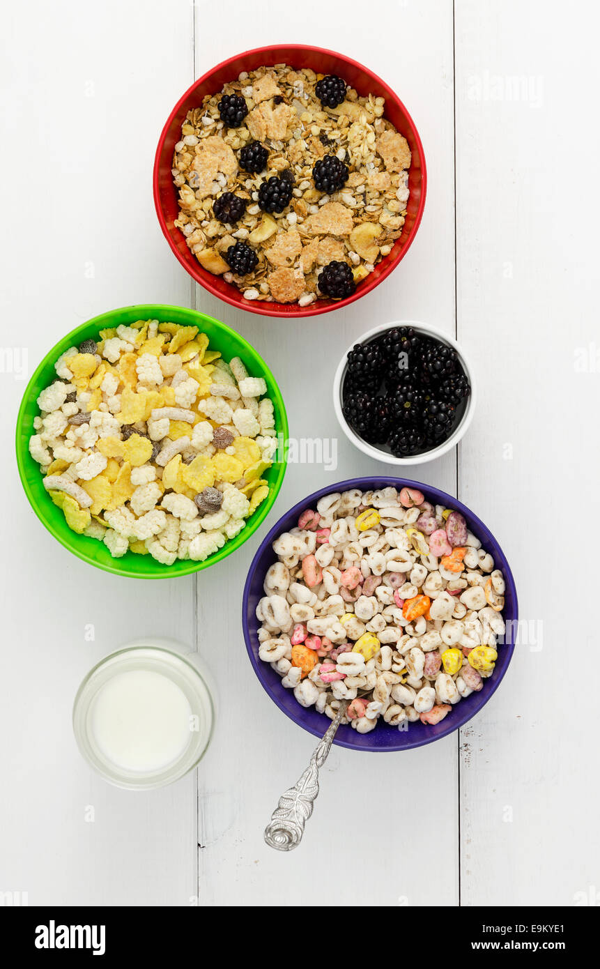Three bowls of cereal over white wooden table. Above view Stock Photo ...