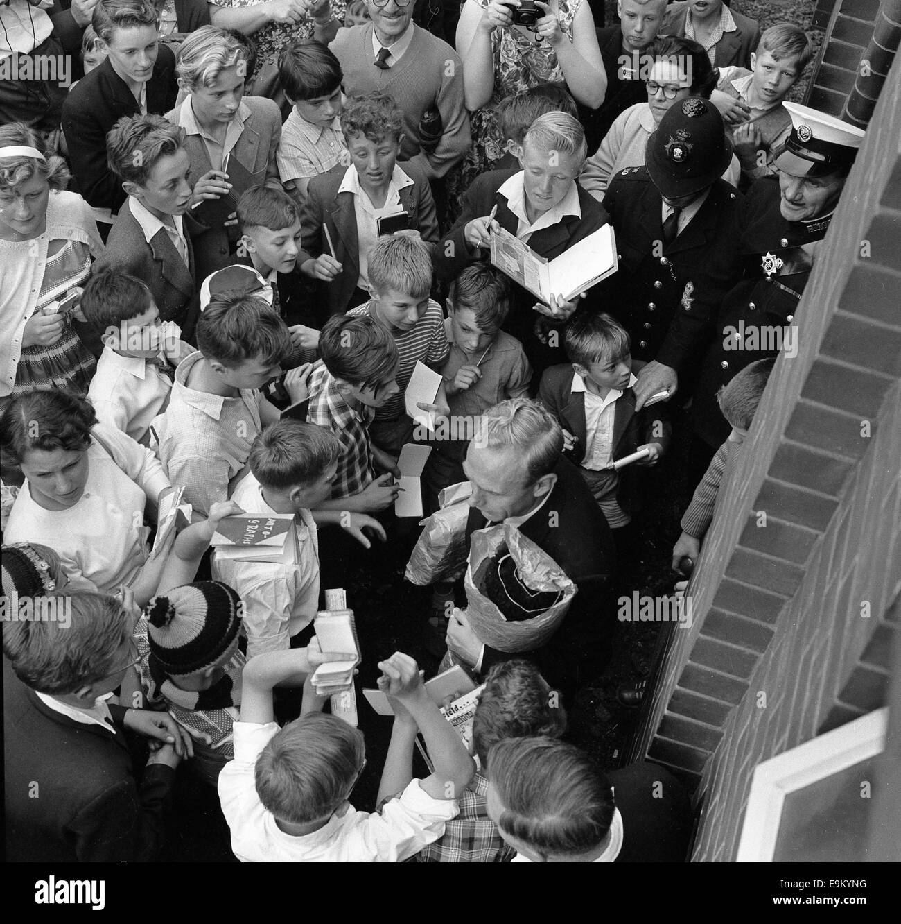 Football fans autograph hunters children crowd around Billy Wright ...