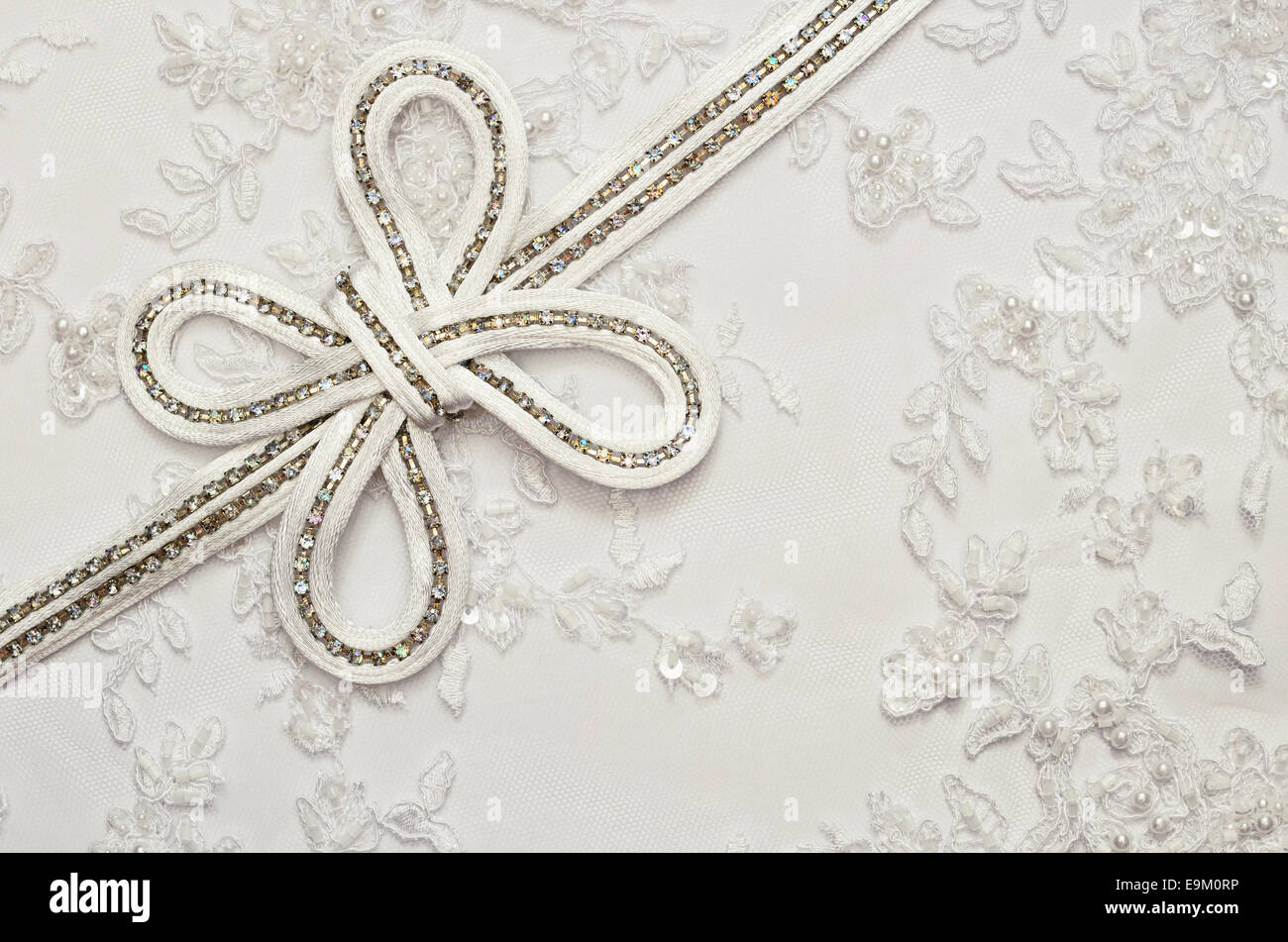 Wedding bow on white lace background Stock Photo - Alamy