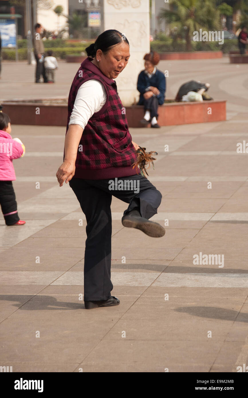 A Chinese woman juggling a shuttlecock, Luzhi, Guizhou Province, China ...