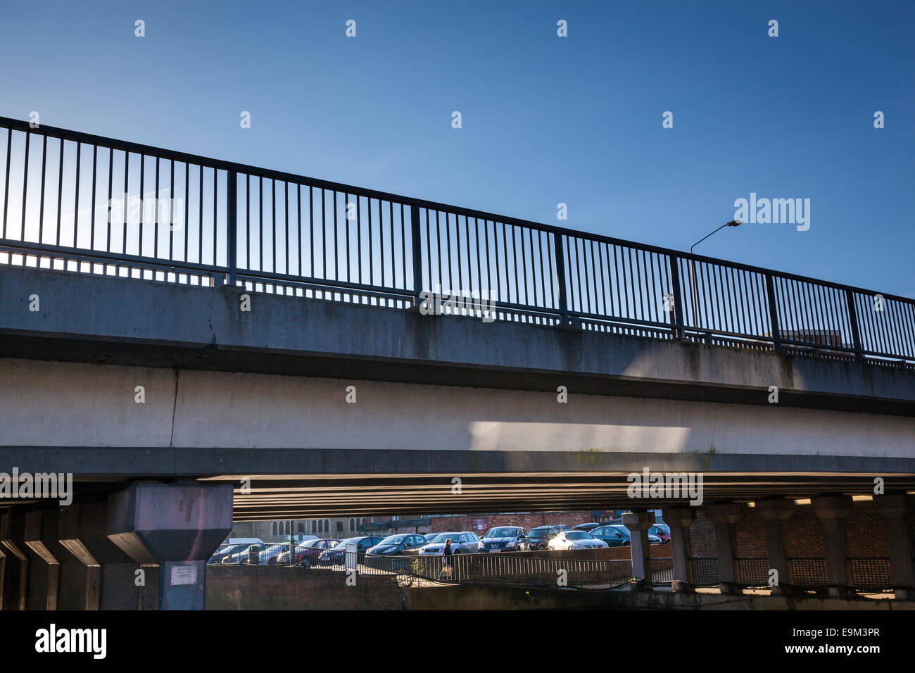 View of the side of a concrete bridge with metal railings as it spans ...