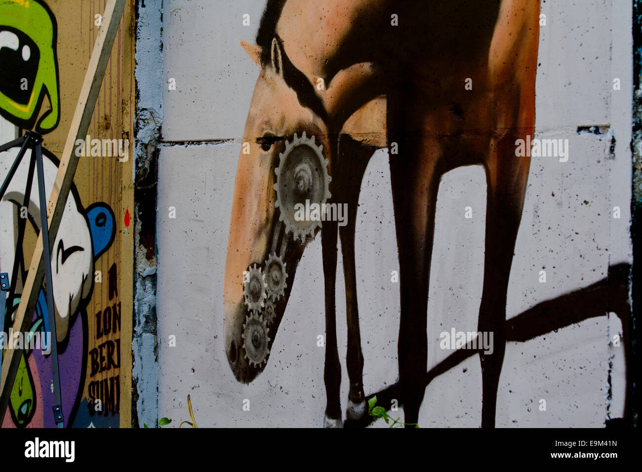 Graffiti street art Berlin Wall colour horse pipe Stock Photo - Alamy